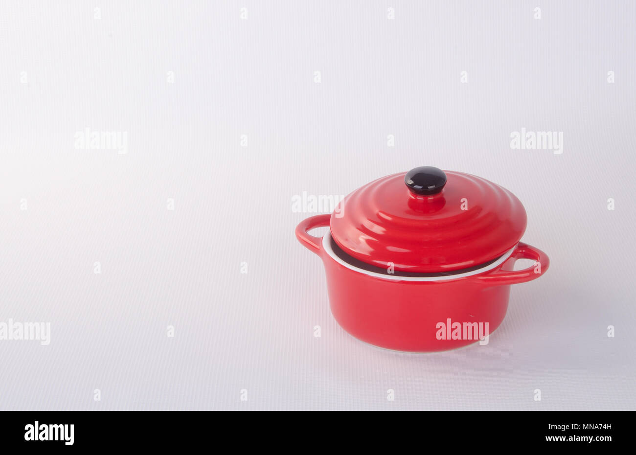 pot or red pot with cover on background Stock Photo - Alamy