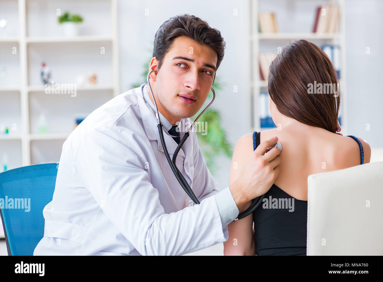 Doctor checking patient with stethoscope Stock Photo - Alamy