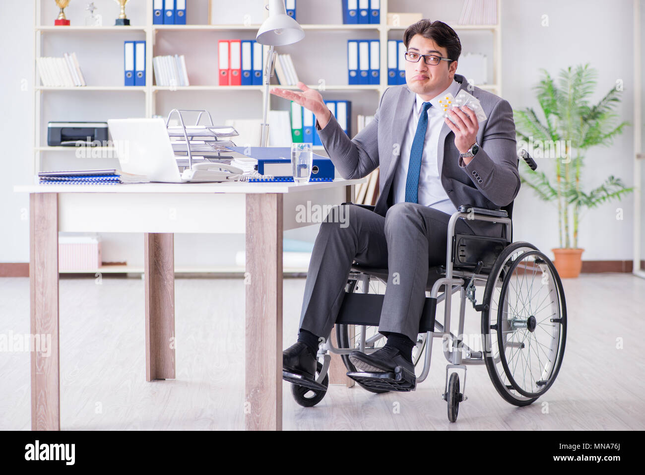 Disabled businessman working in the office Stock Photo - Alamy