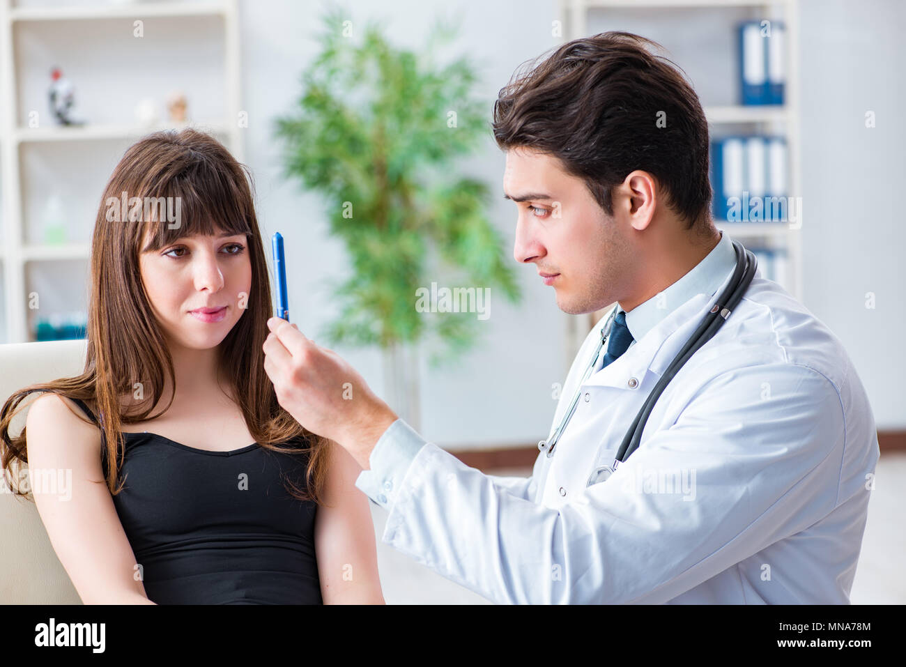 Doctor checking up patient in first aid concept Stock Photo - Alamy