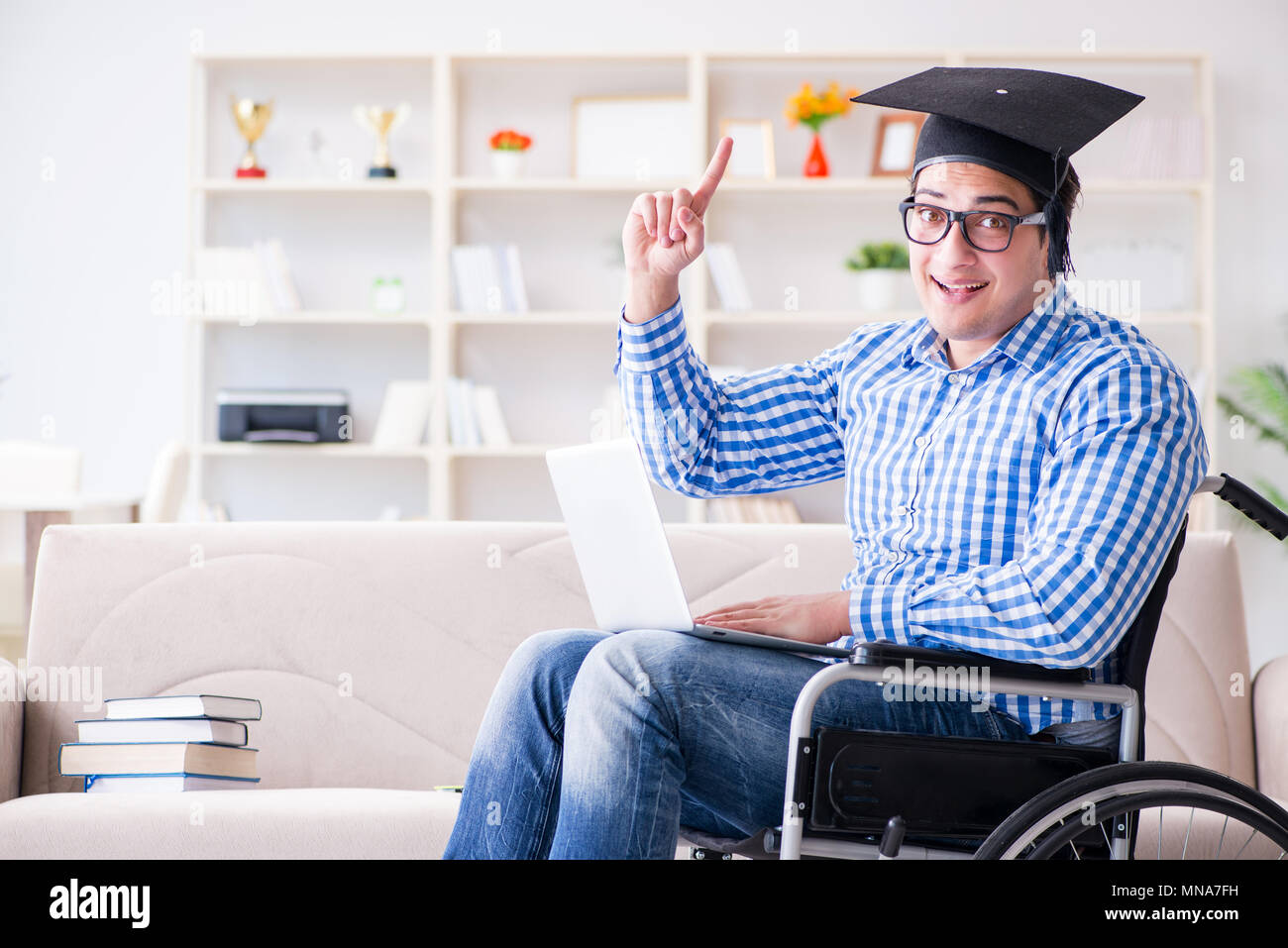 Young student on wheelchair in disability concept Stock Photo - Alamy