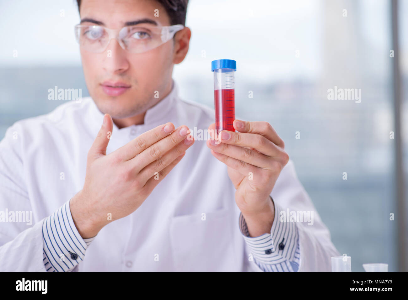 Man doctor checking blood samples in lab Stock Photo - Alamy