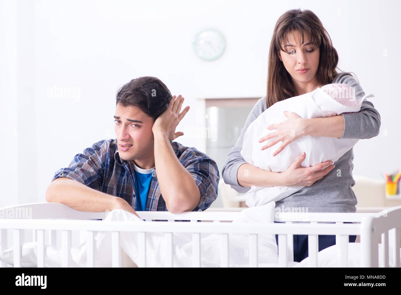 Young dad cannot stand baby crying Stock Photo - Alamy