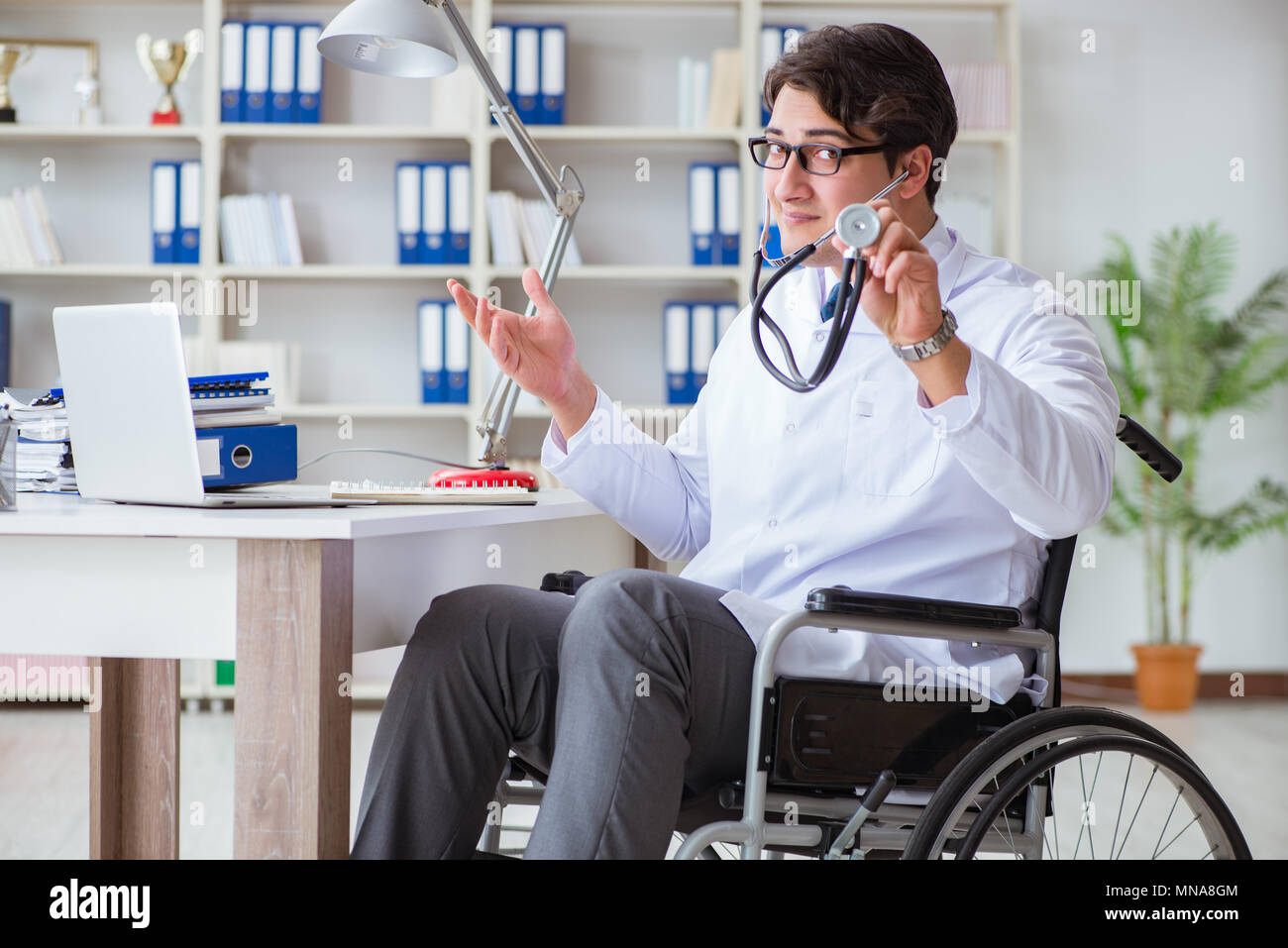 Disabled doctor on wheelchair working in hospital Stock Photo - Alamy