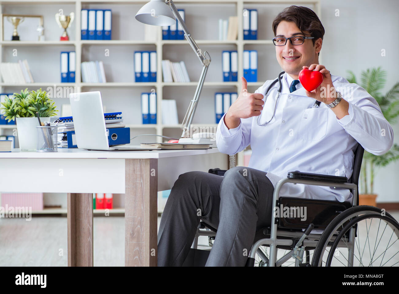 Disabled doctor on wheelchair working in hospital Stock Photo - Alamy