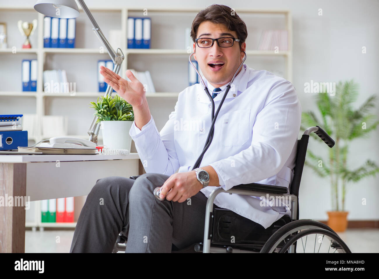Disabled doctor on wheelchair working in hospital Stock Photo - Alamy