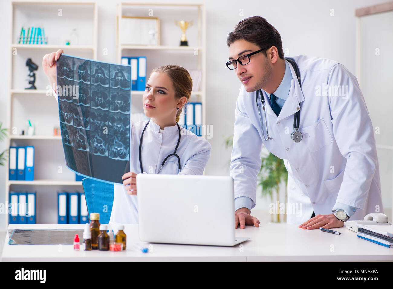 Two doctors examining x-ray images of patient for diagnosis Stock Photo ...