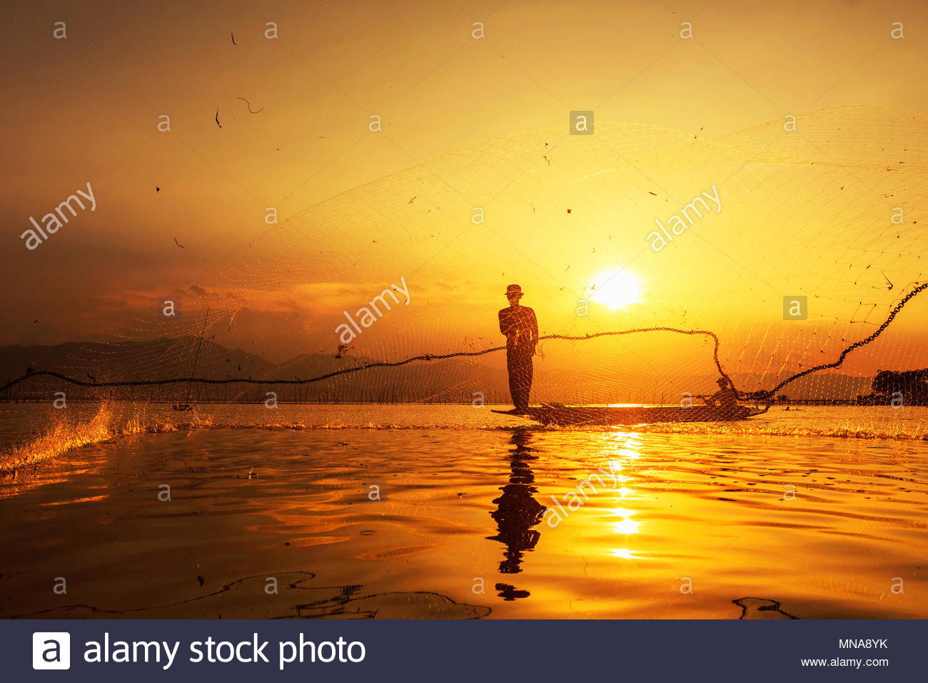 Man Throwing Fishing Net Into Water Stock Photos & Man Throwing Fishing ...