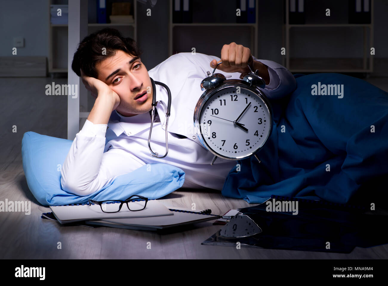 Doctor working night shift in hospital after long hours Stock Photo - Alamy