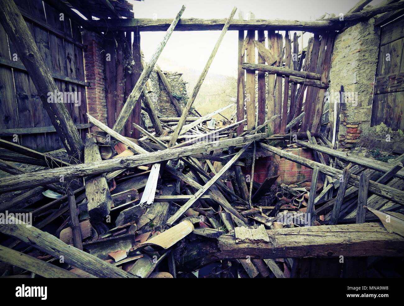 wooden planks and rubble and the ruins of the house completely ...