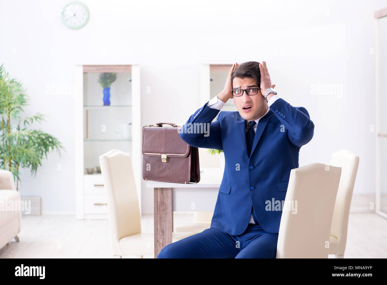 Bankrupt businessman angry and upset at home Stock Photo - Alamy