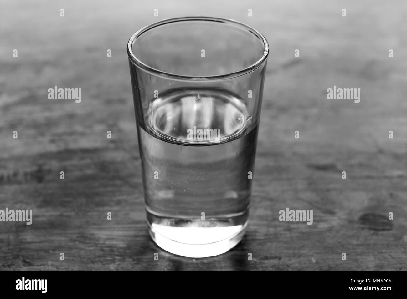 Half full glass of water Black and White Stock Photos & Images - Alamy