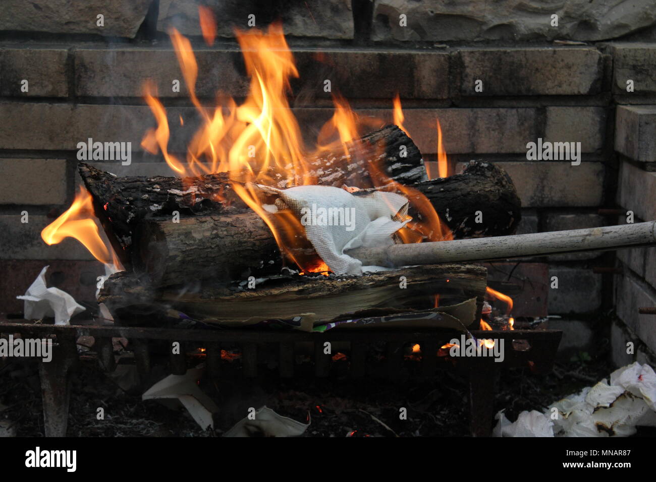 Outdoor brick fireplace with rating fire and a Woodstock with a paper ...
