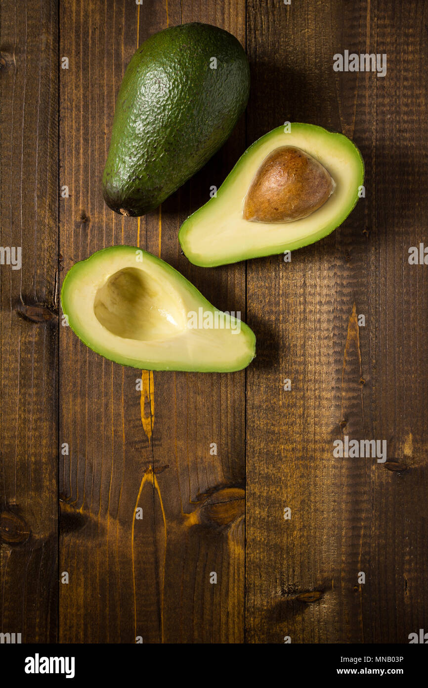 Avocado on Dark Wood Background. Healthy Food Concept Stock Photo - Alamy