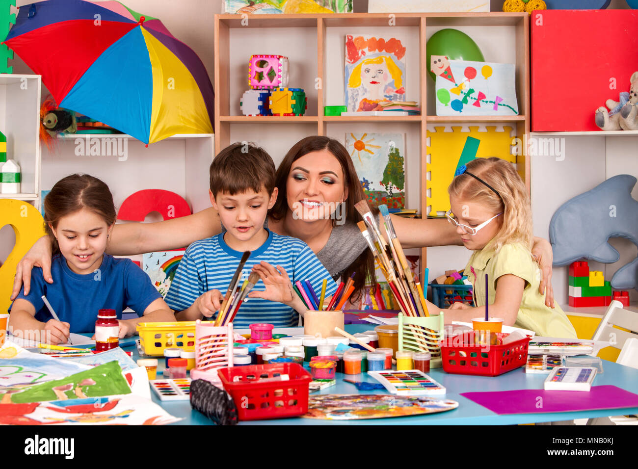 Children painting and drawing together. Craft lesson in primary school ...