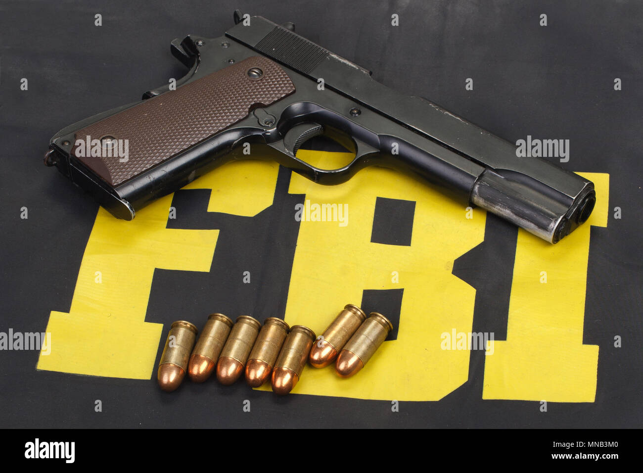 colt government m1911 handgun with ammo on fbi uniform Stock Photo - Alamy