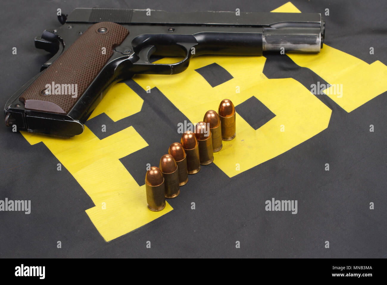 colt government m1911 handgun with ammo on fbi uniform Stock Photo - Alamy