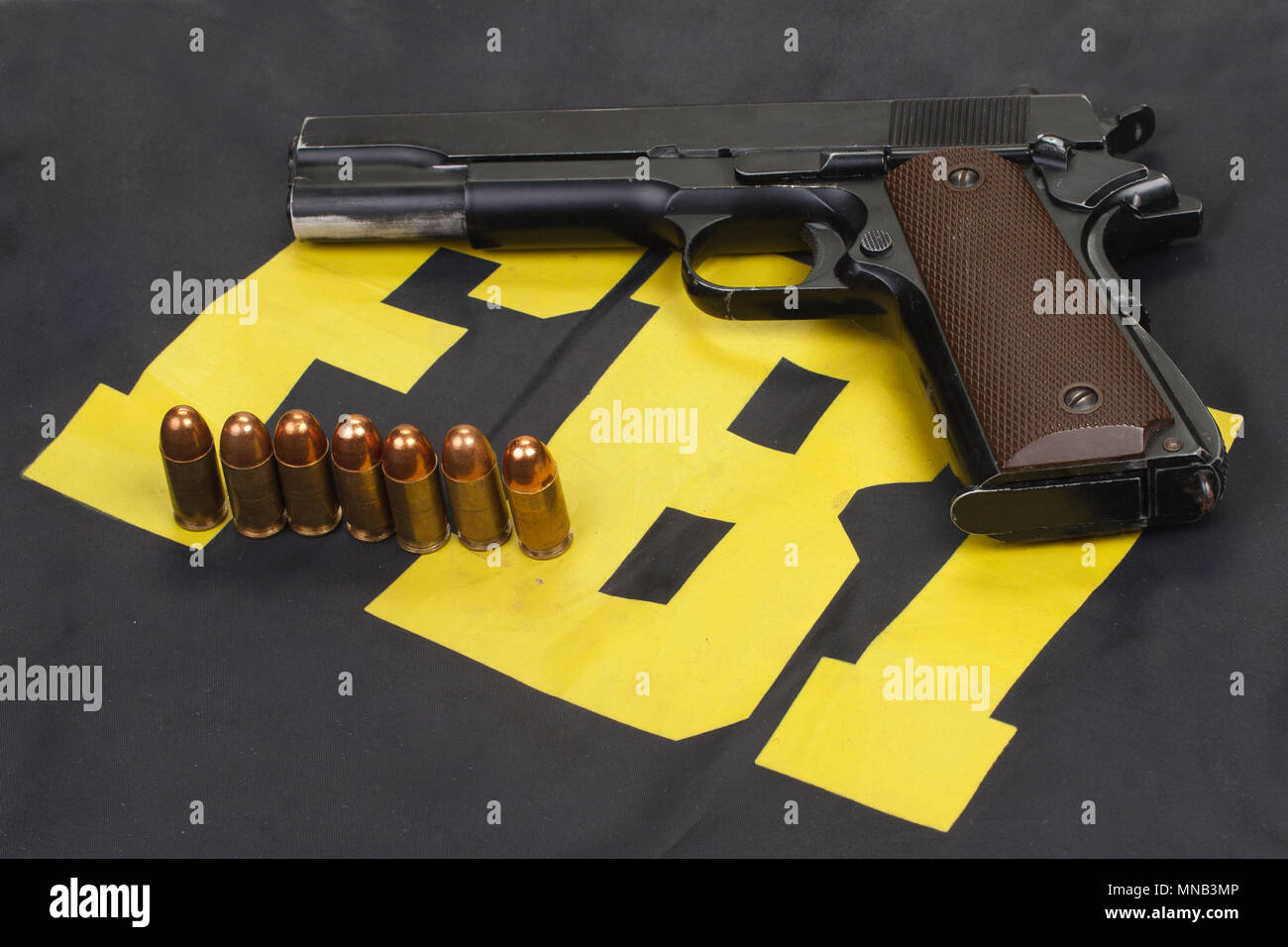 colt government m1911 handgun with ammo on fbi uniform Stock Photo - Alamy