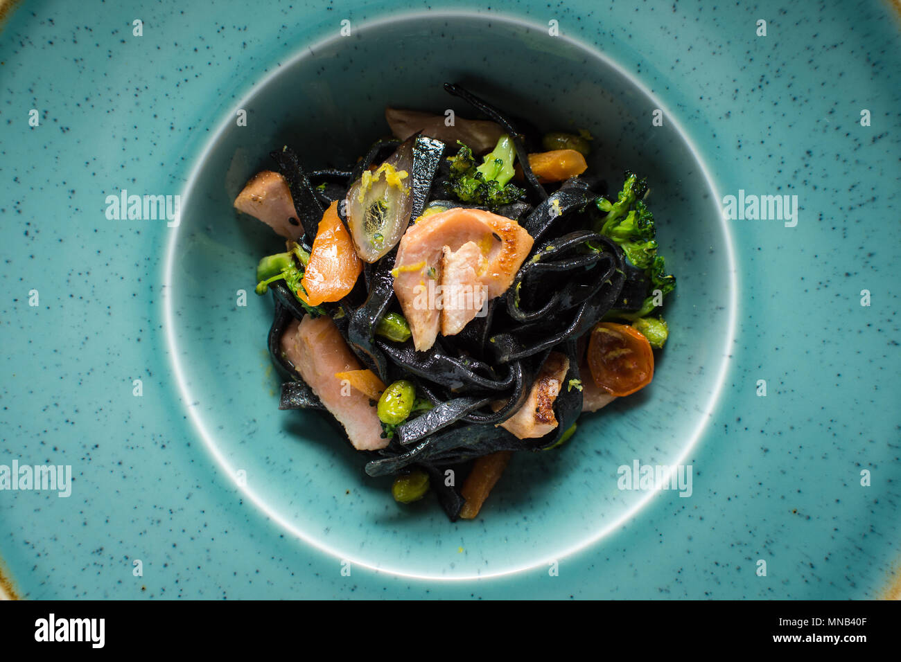 Cuttlefish Ink Black Spaghetti with Salmon and Vegetables Stock Photo ...