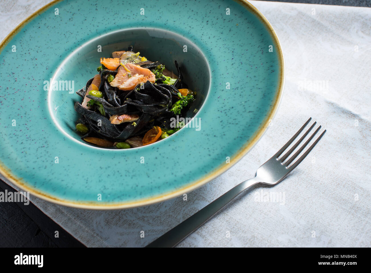 Cuttlefish Ink Black Spaghetti with Salmon and Vegetables Stock Photo ...