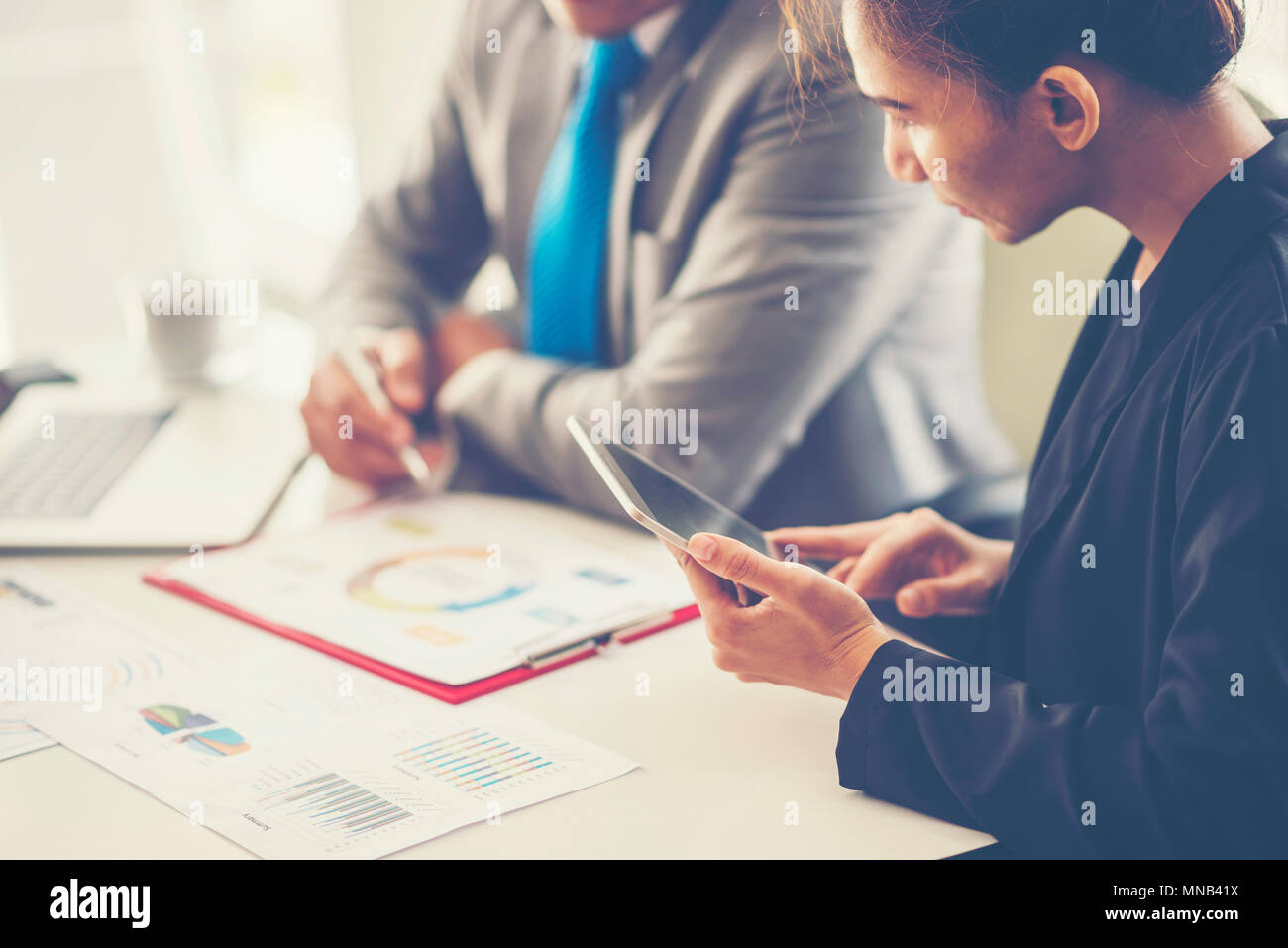 Image of two young businessmen using touchpad at meeting Stock Photo ...