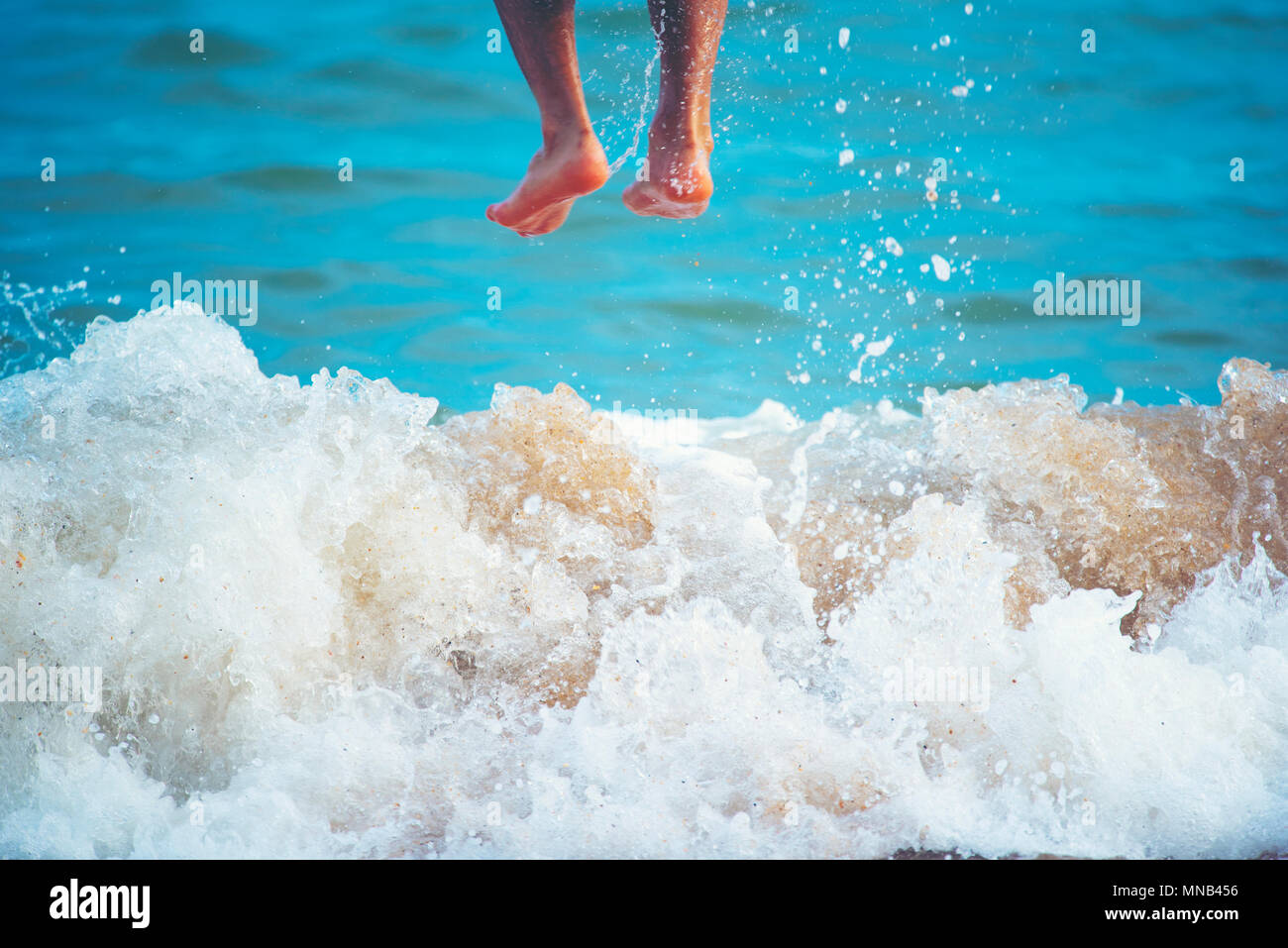 Jumping over the waves hi-res stock photography and images - Alamy