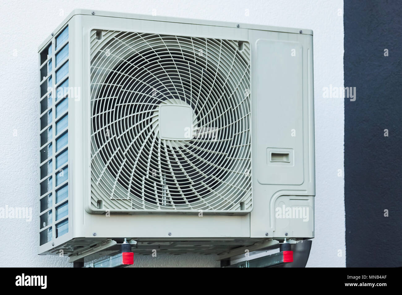 Air conditioner outdoor unit installed on the wall, viewed in close-up ...