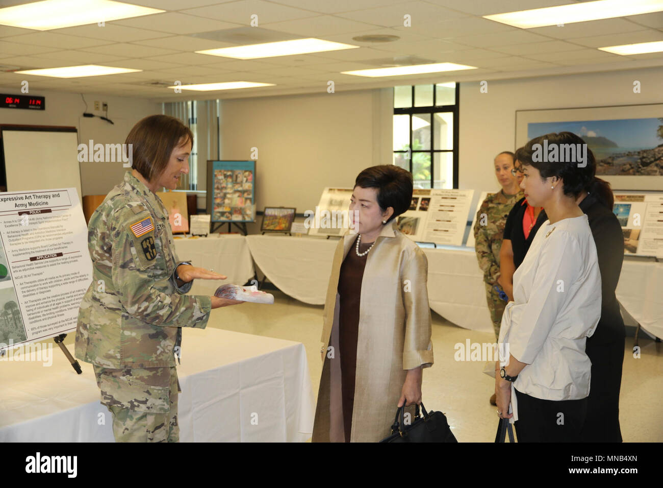 Col. Deydre Teyhen provides an example of Soldier art to visitors from ...