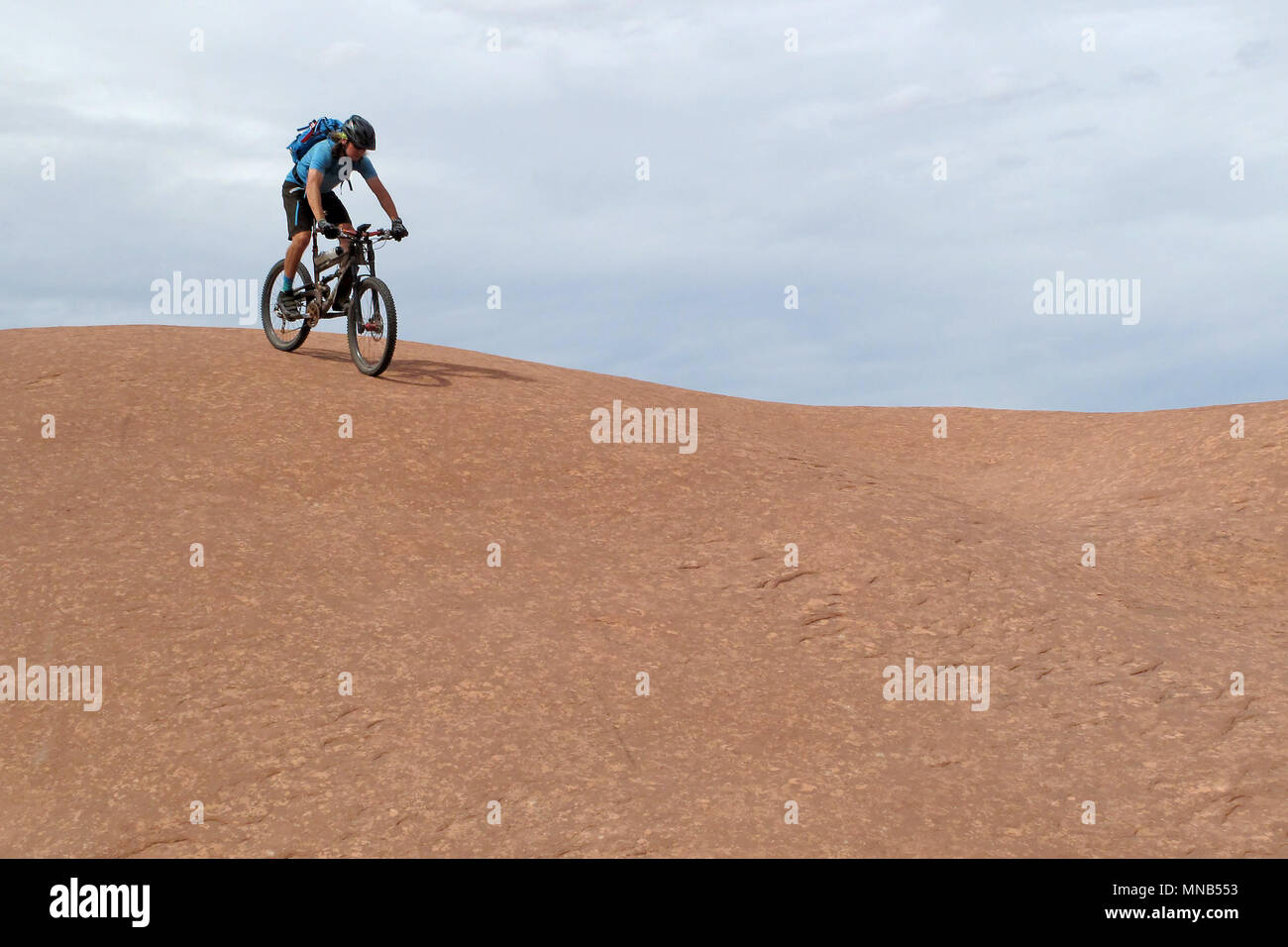 Mountain biker riding downhill the famous Slickrock trail, Moab, USA ...