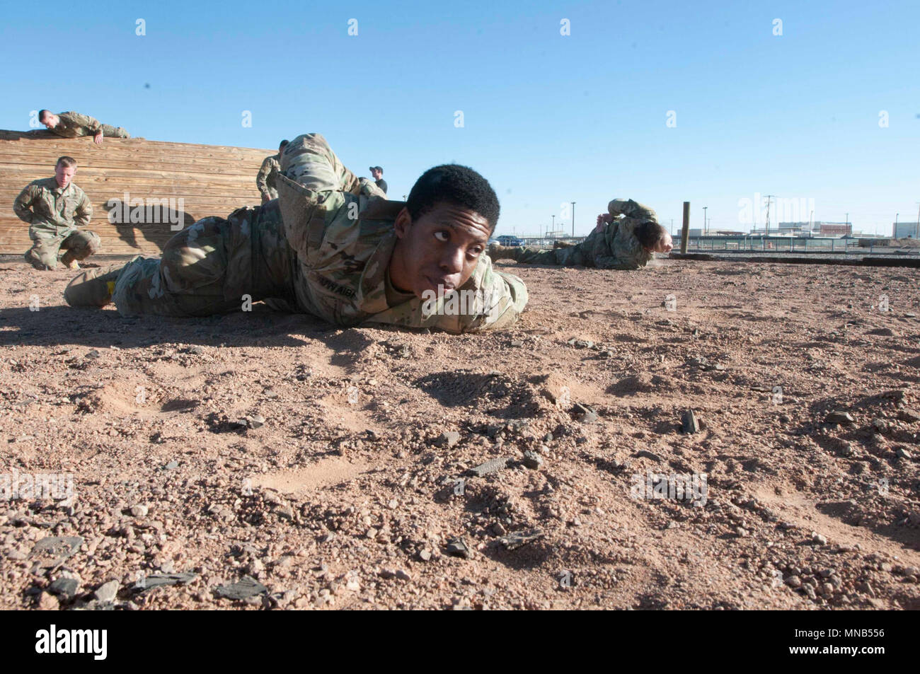 Air assault trainees conduct the prisoner of war crawl during an ...
