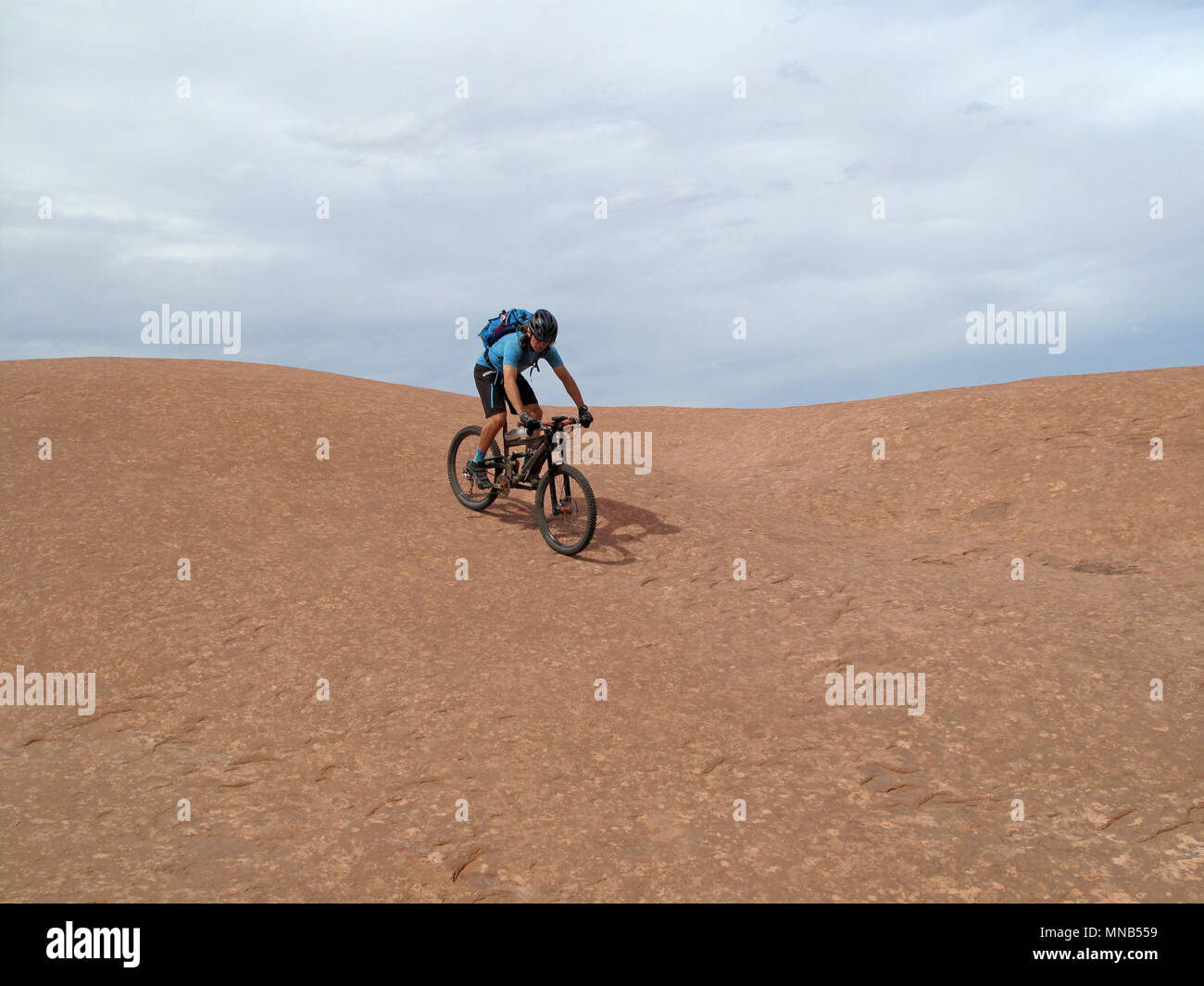 Mountain biker riding downhill the famous Slickrock trail, Moab, USA ...