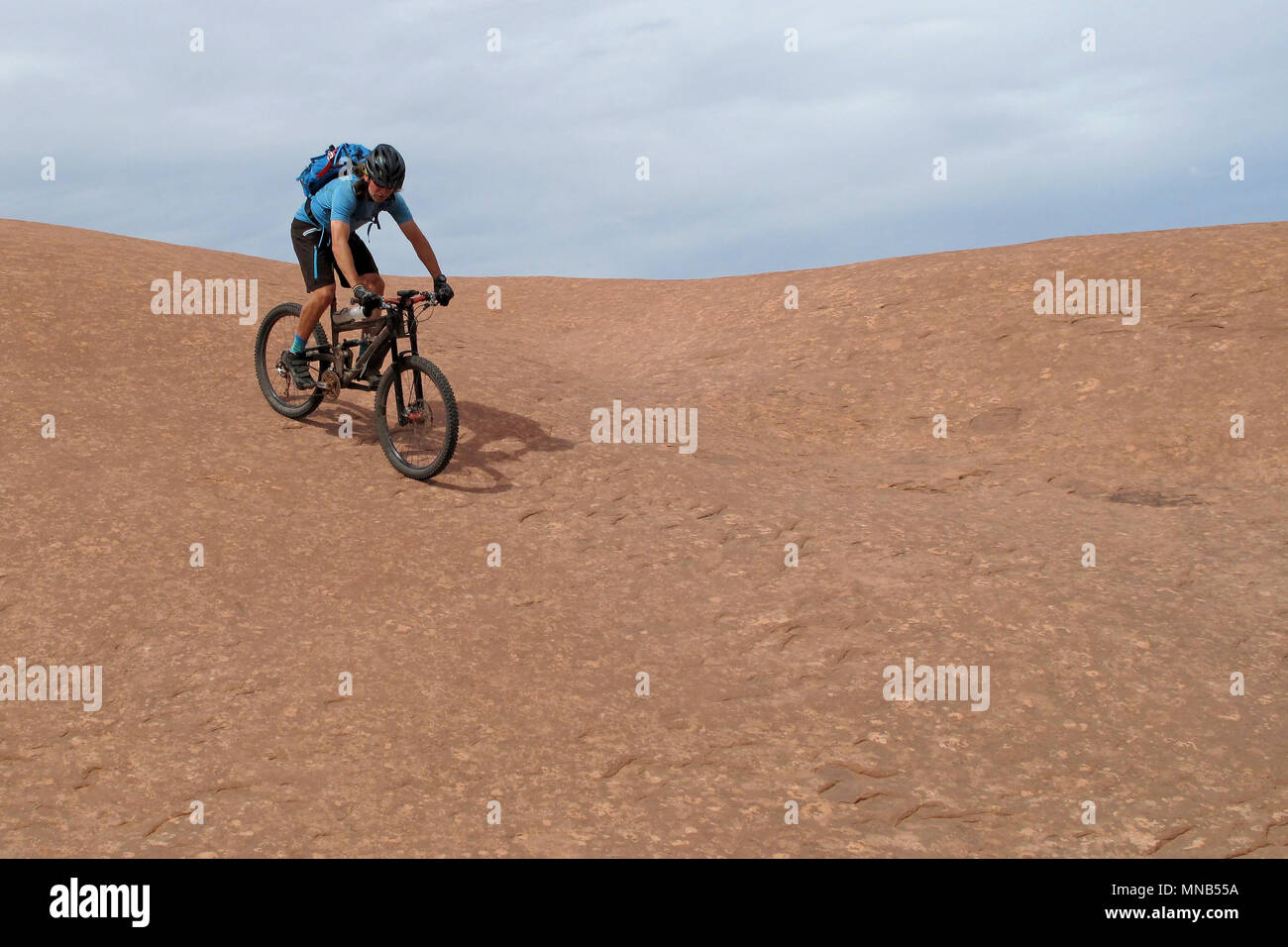 Mountain biker riding downhill the famous Slickrock trail, Moab, USA ...