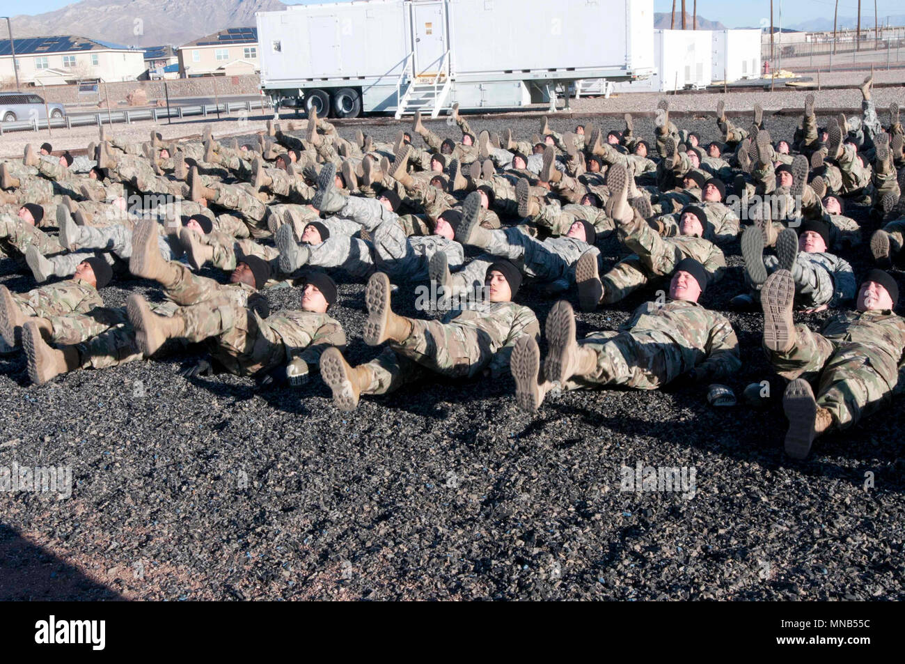 Air assault trainees perform flutter kicks during an air assault drill ...