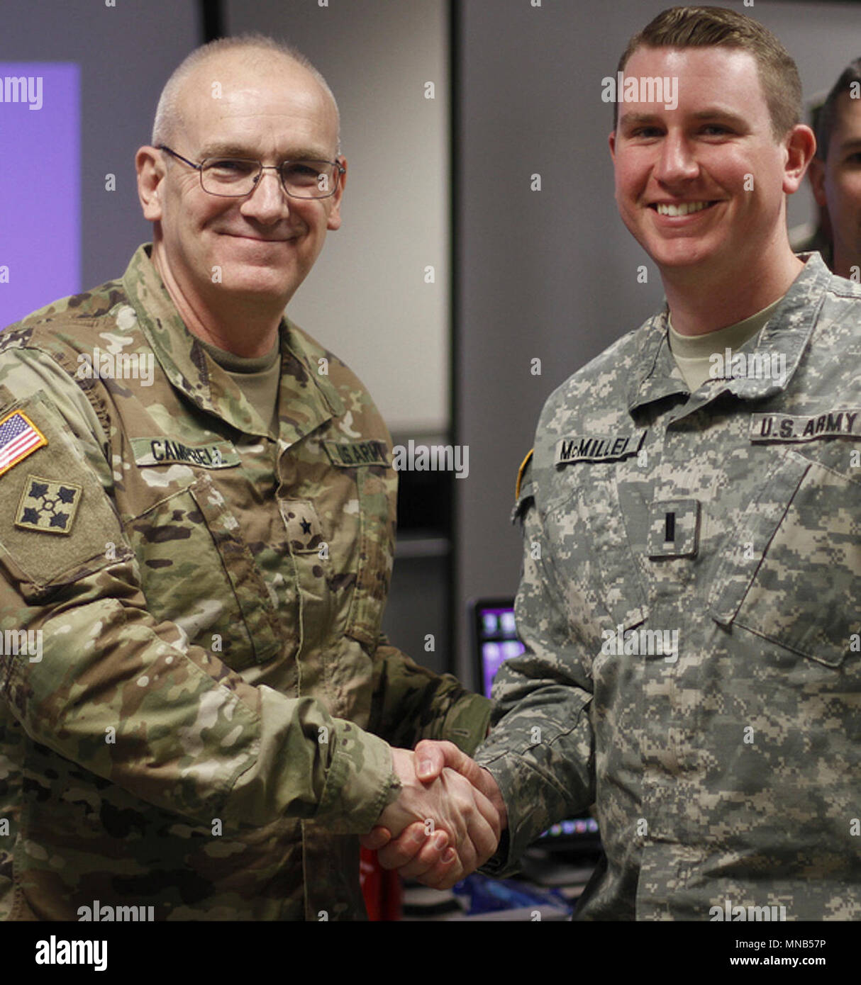 Brig. Gen. Scott Campbell presents 1st. Lt. Cody McMillen a coin for ...