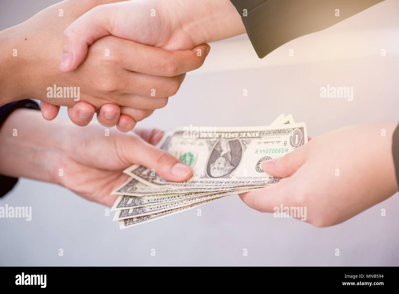 business handshake and teamwork for money and success goal Stock Photo ...