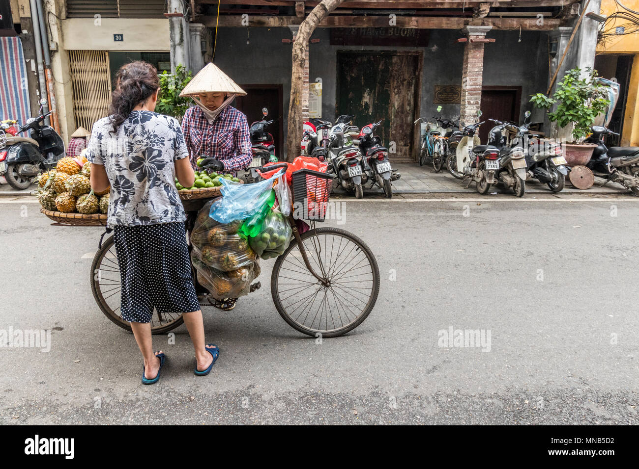 Vendors at work in city of Hanoi Vietnam Stock Photo - Alamy