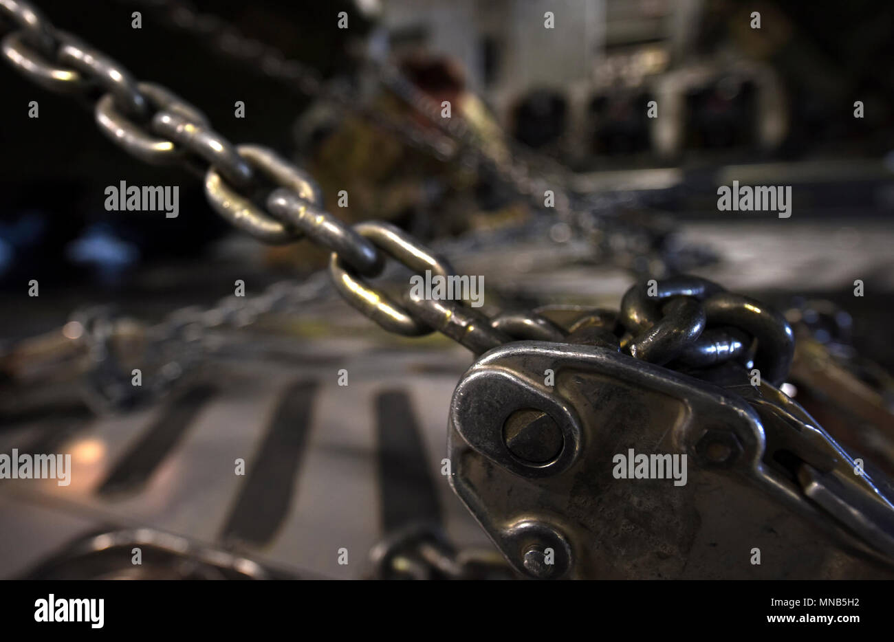 Chains secure a U.S. Army Interim Armored Vehicle Stryker inside a C-17 ...
