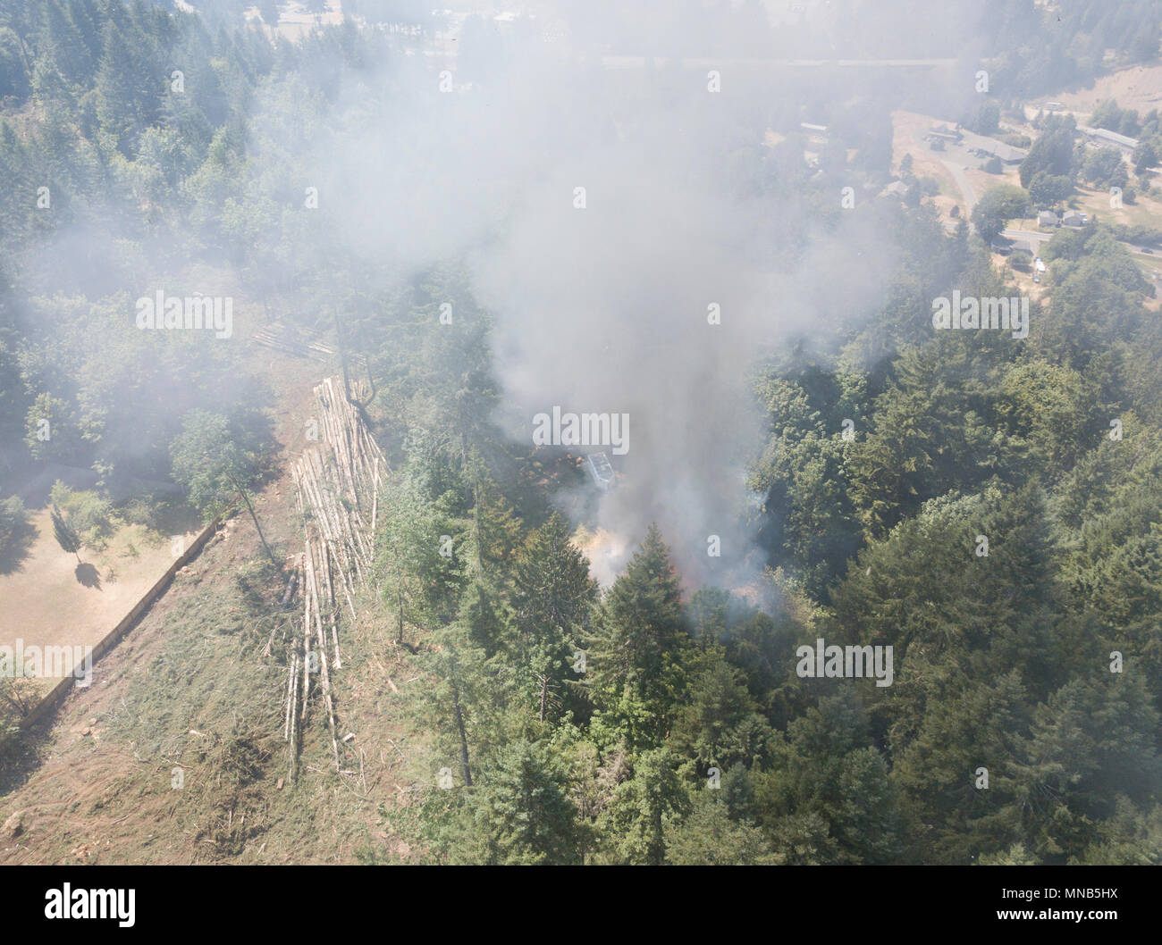 Flying camera coverage of a housefire in the woods Stock Photo - Alamy