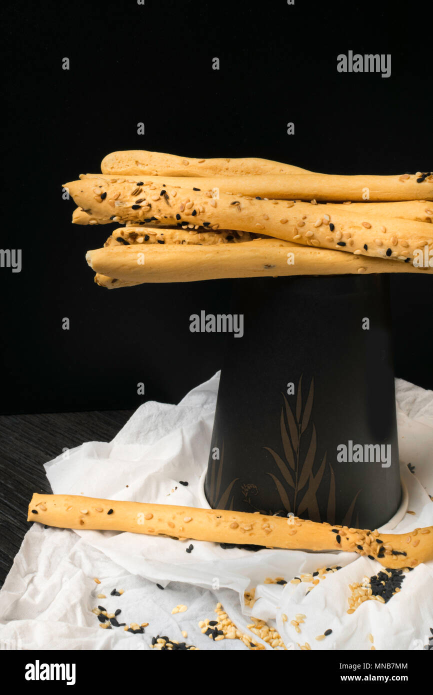homemade snack, baked sticks with sesame and black cumin on the paper ...