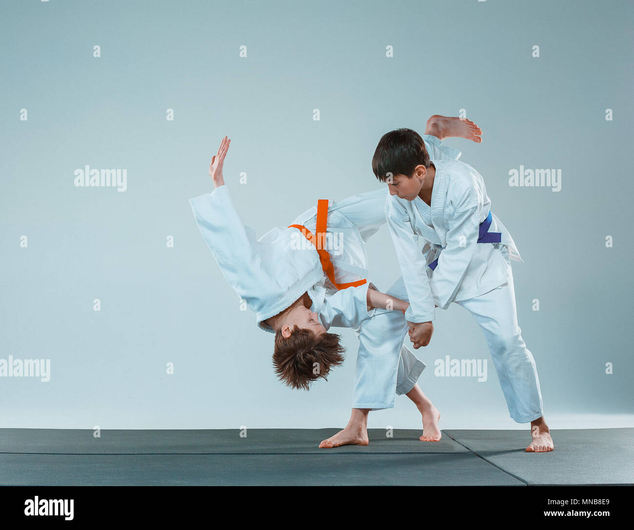 The two boys fighting at Aikido training in martial arts school ...