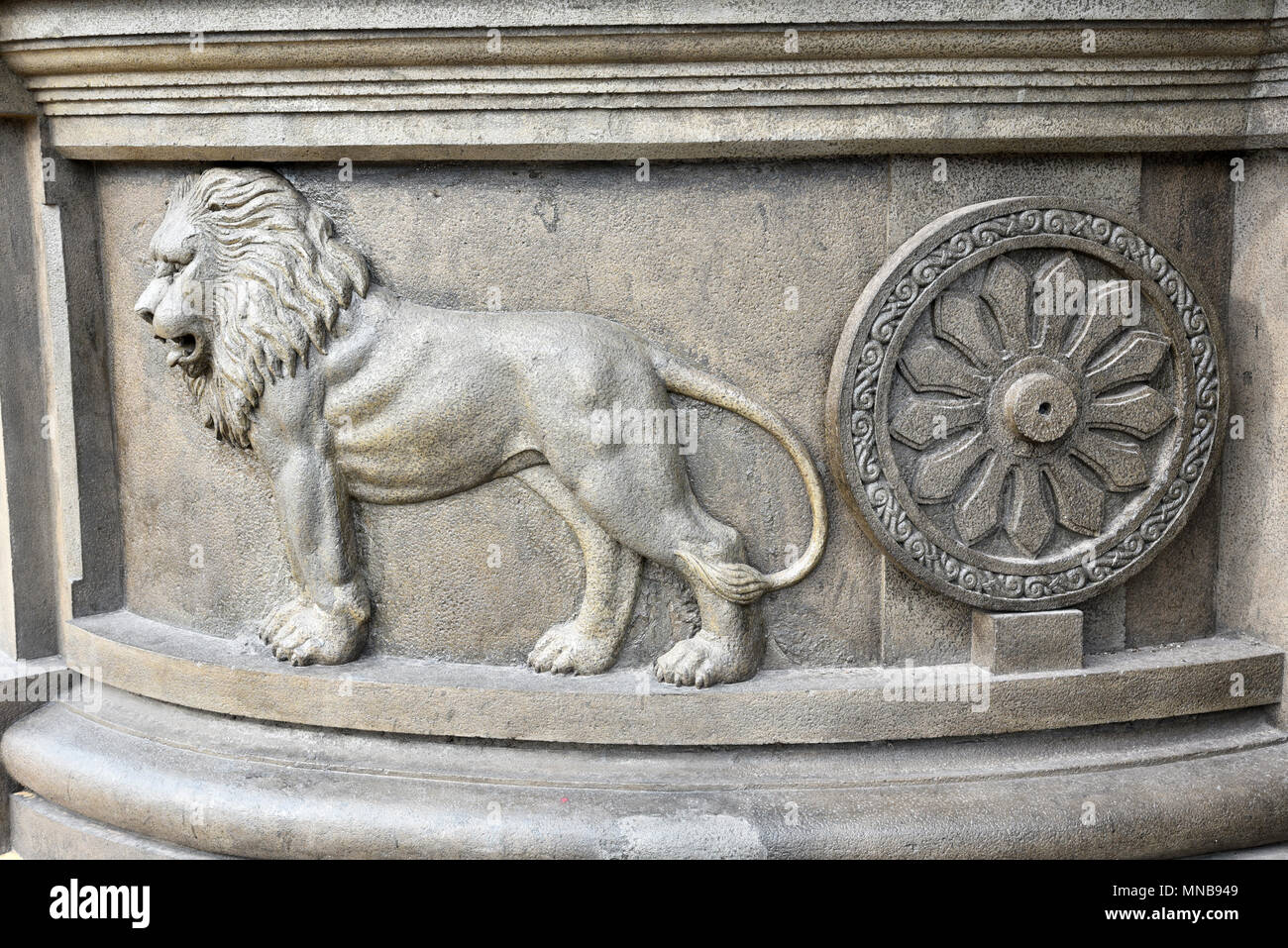 stone carving of lion and wheel at a park inkerala ,india Stock Photo ...