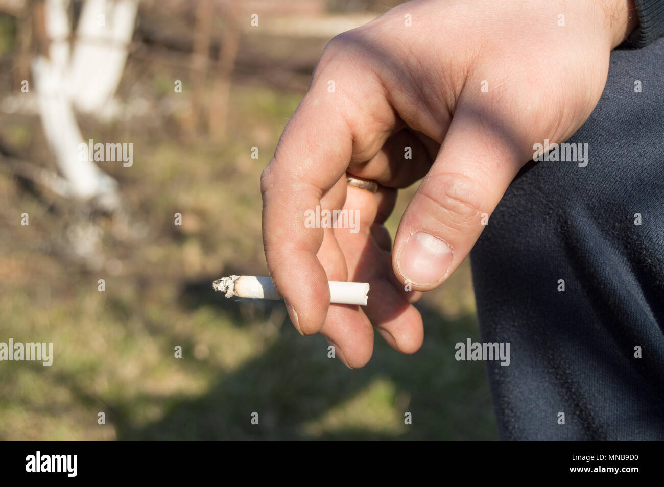 Man Holding Cigarette In Hand High Resolution Stock Photography and ...
