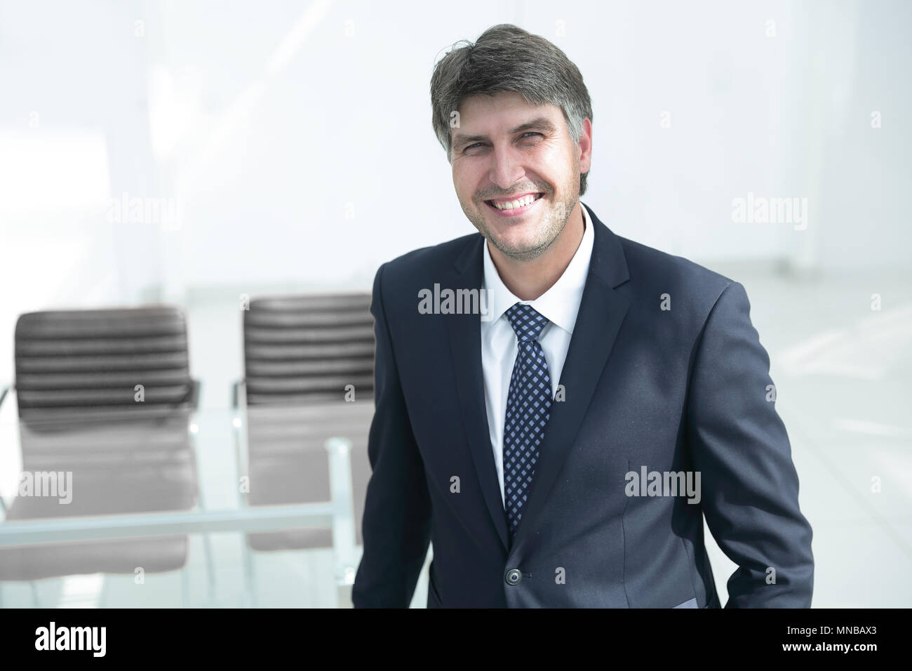 successful businessman standing by the desk Stock Photo - Alamy