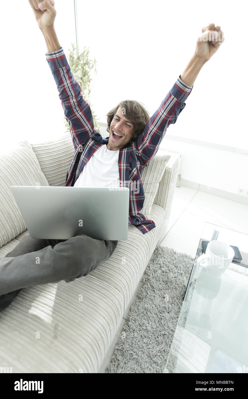 very happy guy working with laptop at home Stock Photo - Alamy