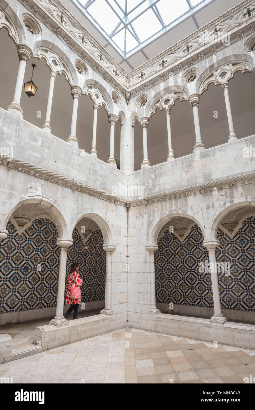 Portugal tile museum, view of a tourist walking through a cloister in ...