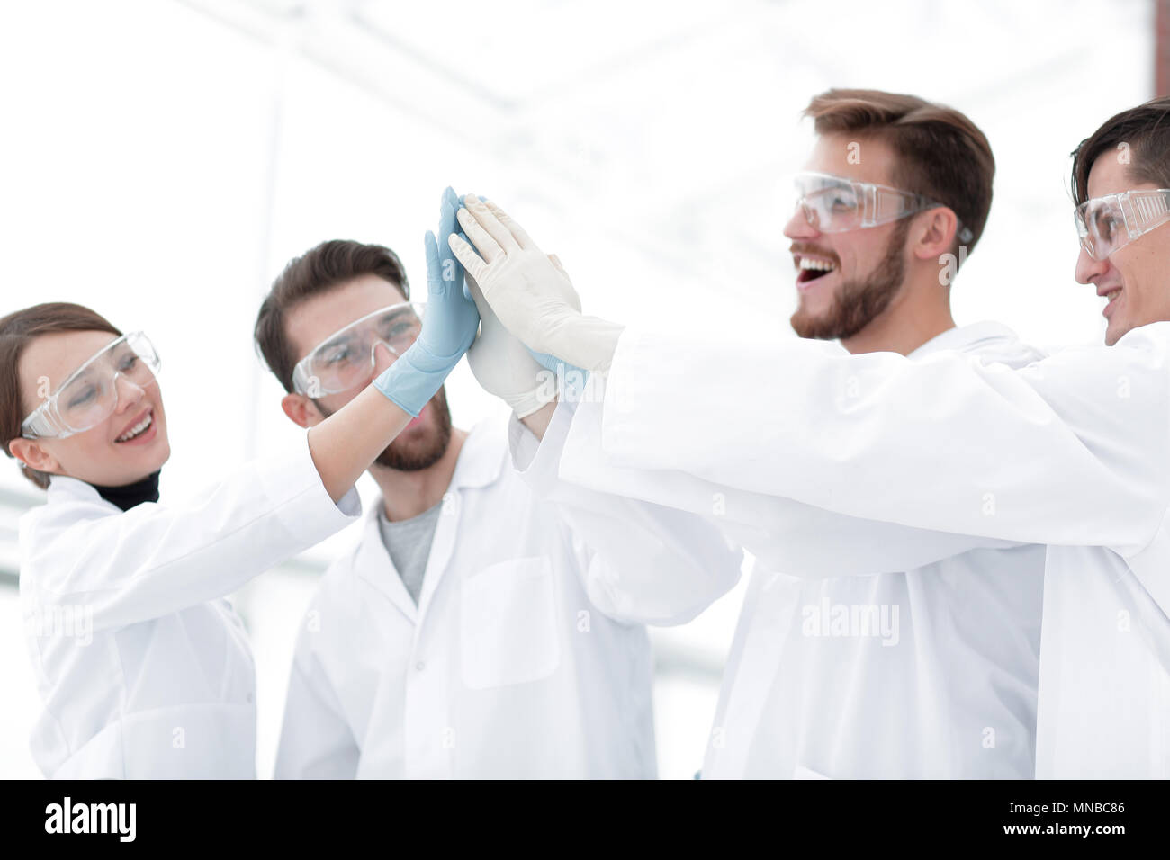 scientists giving each other a high five Stock Photo - Alamy