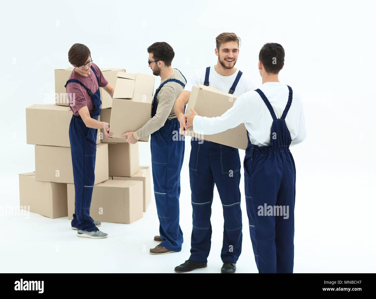 Movers lifting stack of cardboard moving boxes isolated on white Stock ...