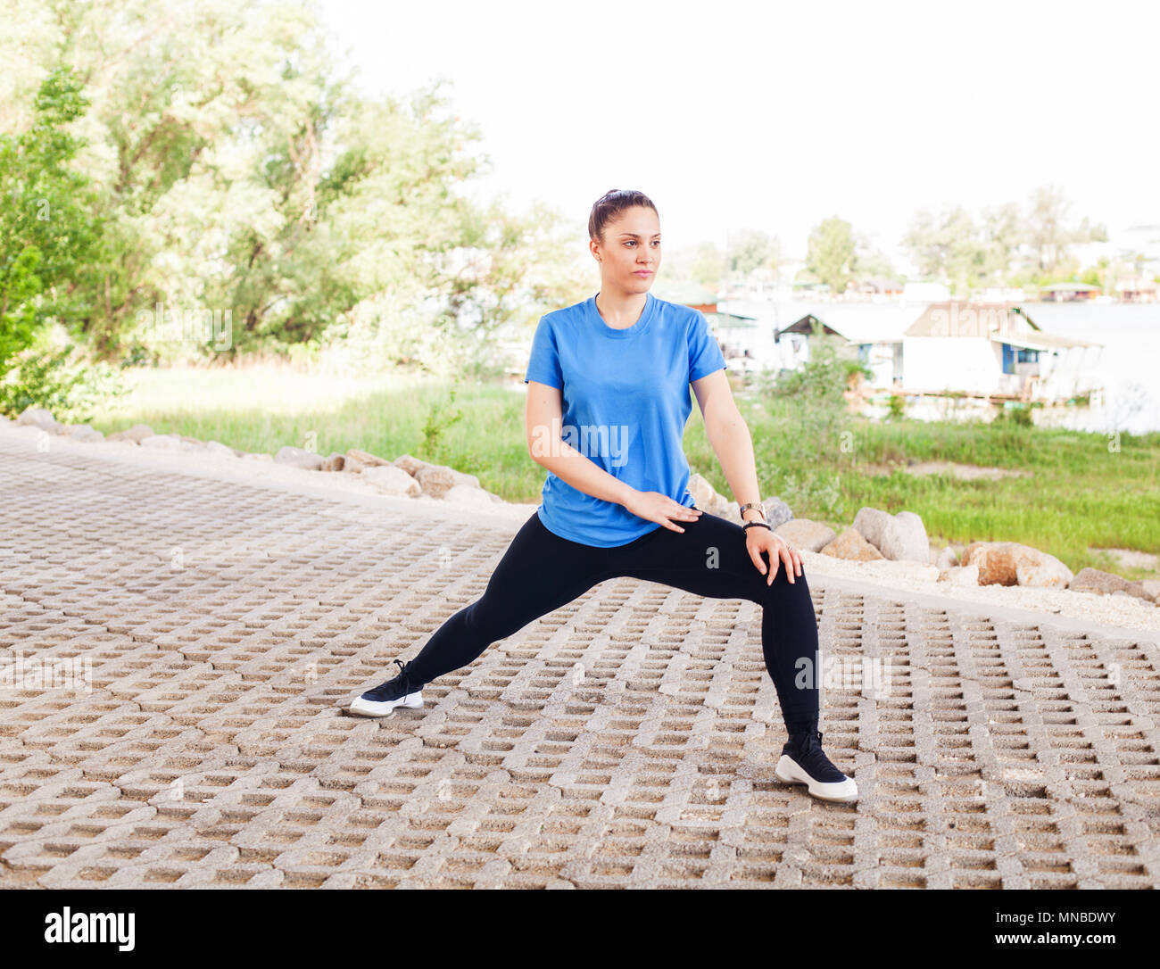 Young Fitness Woman doing workout outdoor, stretching exercise Stock ...