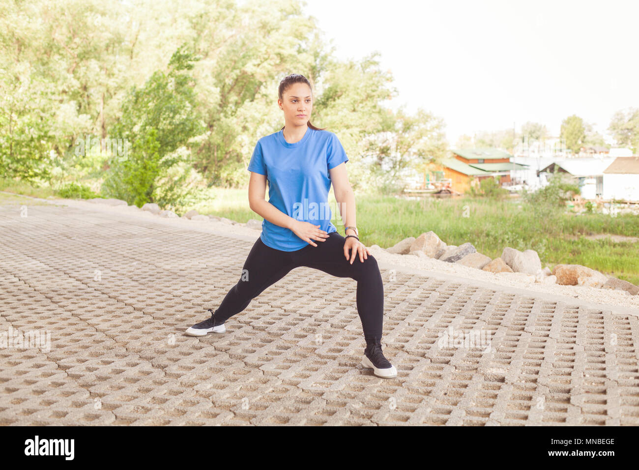 Young Fitness Woman doing workout outdoor, stretching exercise Stock ...