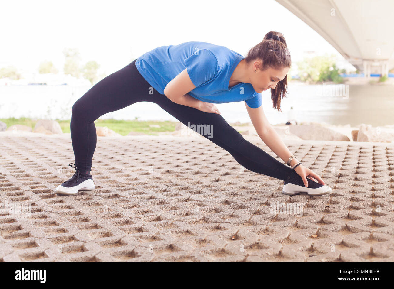 Young Fitness Woman doing workout outdoor, stretching exercise Stock ...
